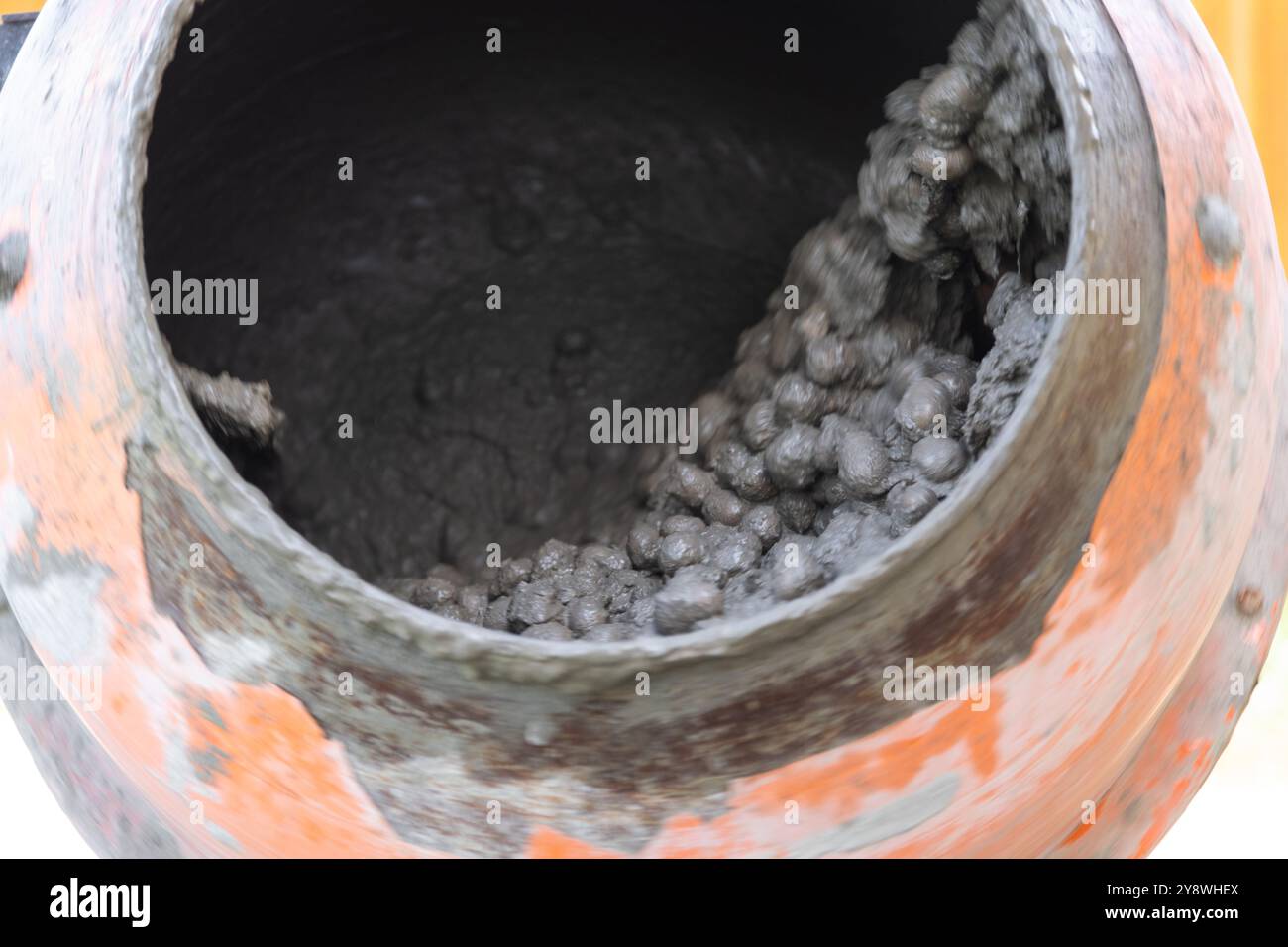 Mixing mortar in a handheld portable concrete mixer Stock Photo - Alamy