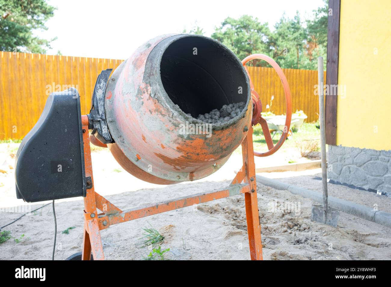 Mixing mortar in a handheld portable concrete mixer Stock Photo - Alamy