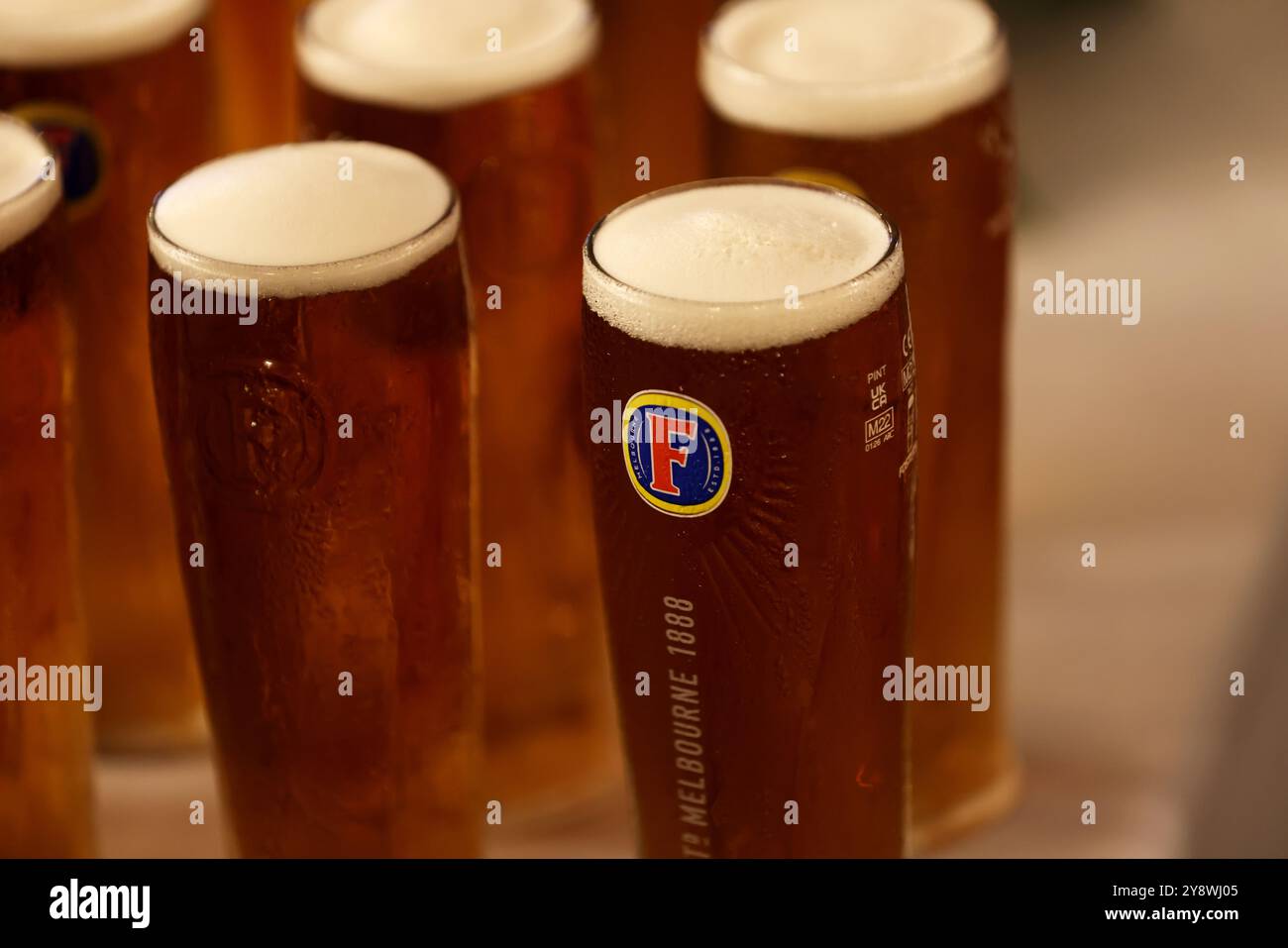 Pints of Fosters pictured on a bar in London, UK Stock Photo - Alamy