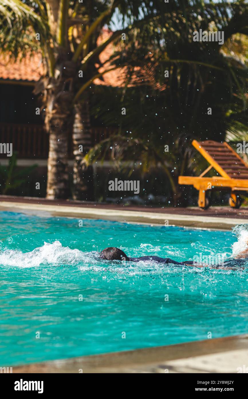 Man Enjoying a Refreshing Swim in Clear Blue Water. Sunny Summer Day by ...