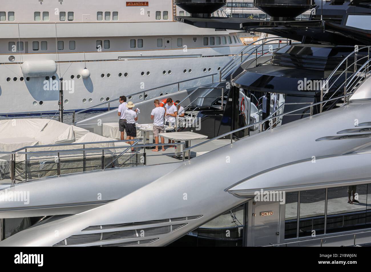 Crew members ensuring cleaning, maintenance on the open deck of a super ...