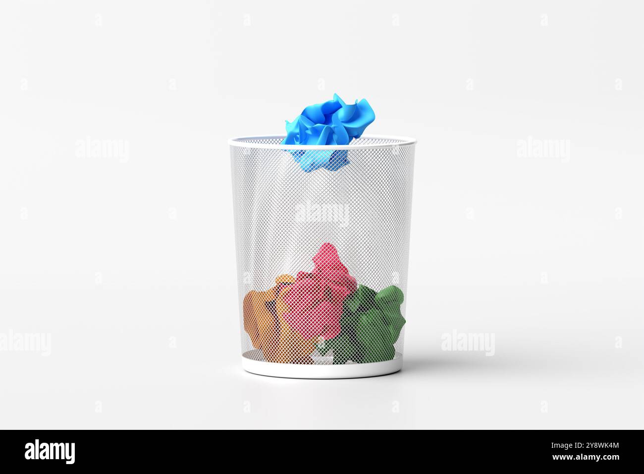 Colorful crumpled papers thrown into the office trash bin on white ...