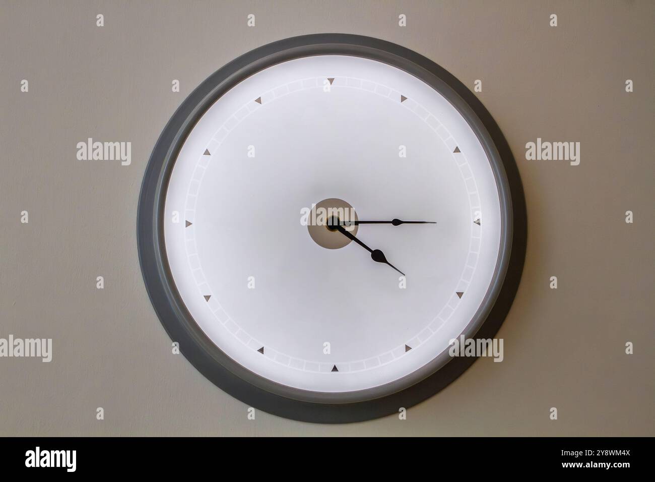Minimalistic Wall Clock Showing Five O'Clock Stock Photo - Alamy