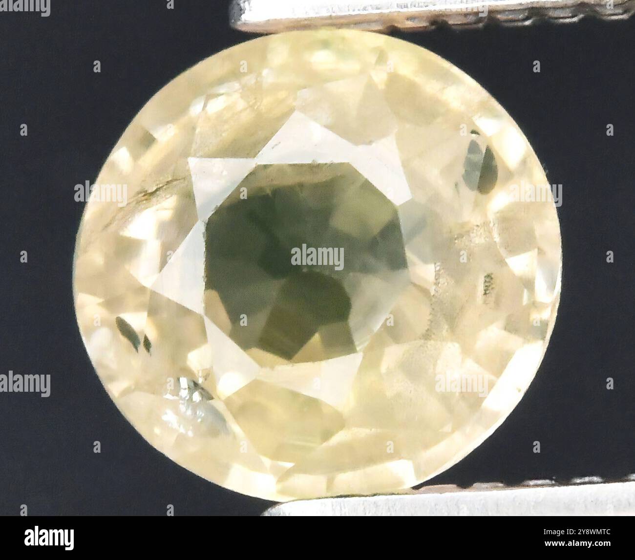 Radiant Yellow Gemstone with Intricate Faceting and Natural Inclusions ...