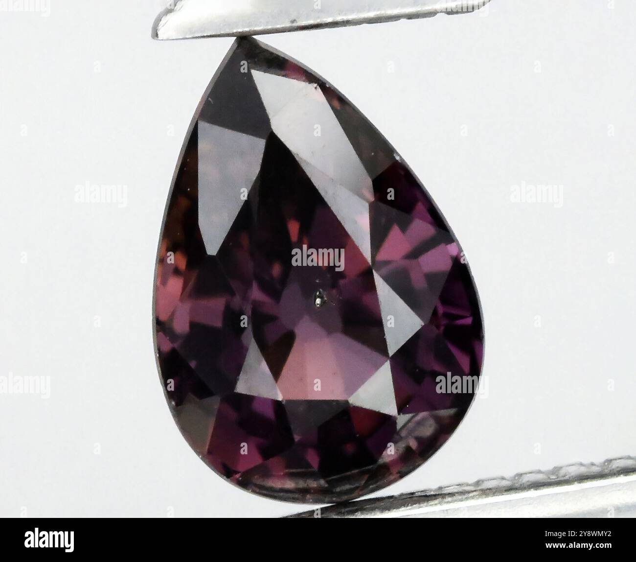 Exquisite Tear-Drop Shaped Purple Gemstone with Intricate Facet Cuts ...