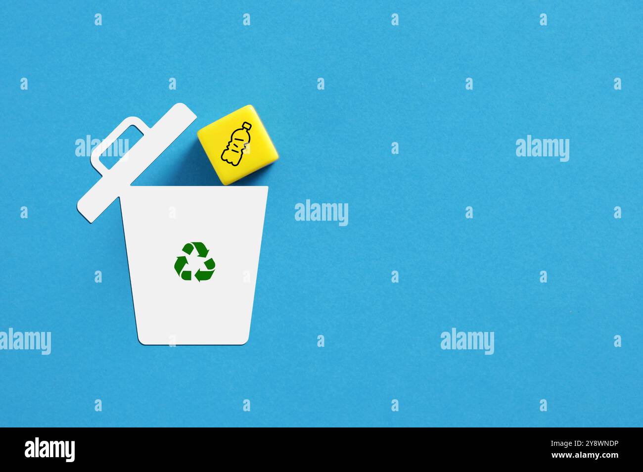 Conceptual image of a plastic bottle falling into a recycling bin ...