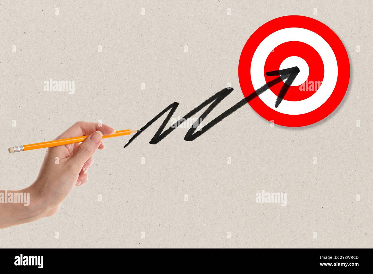 Hand holding a pencil and drawing an arrow towards the target ...