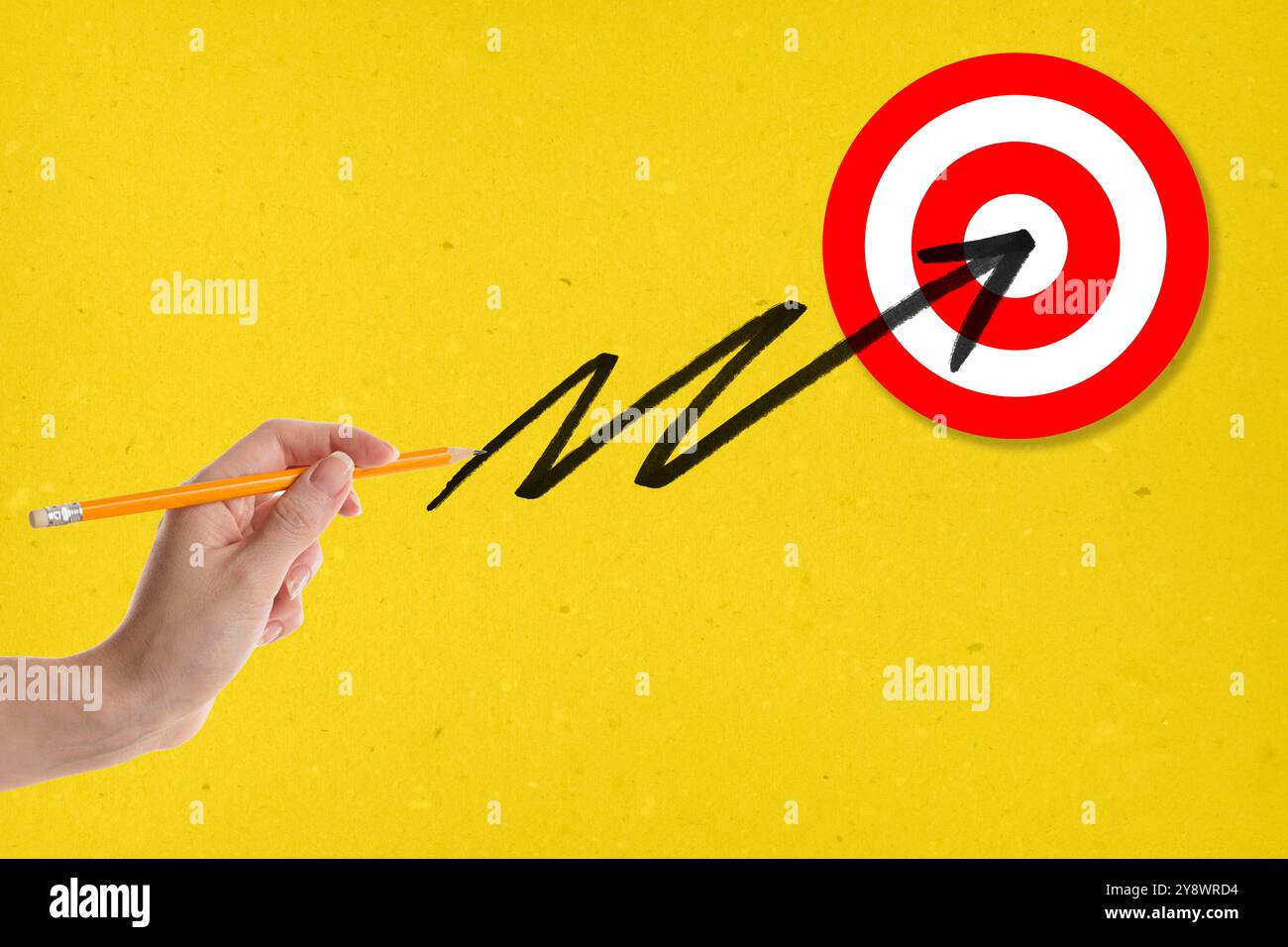 Hand holding a pencil and drawing an arrow towards the target ...