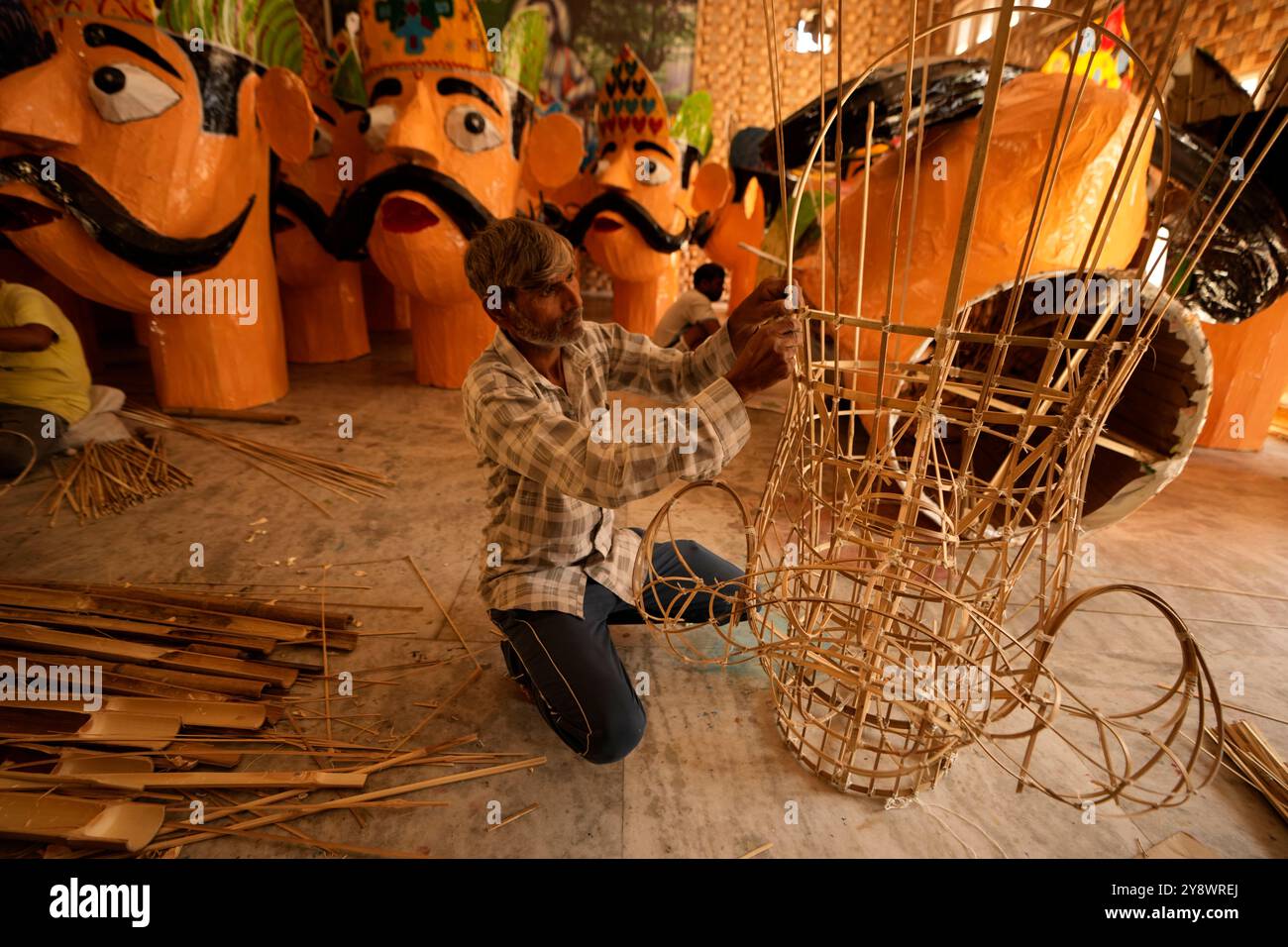 An Indian artist makes effigies of the antagonists in the Hindu epic ...