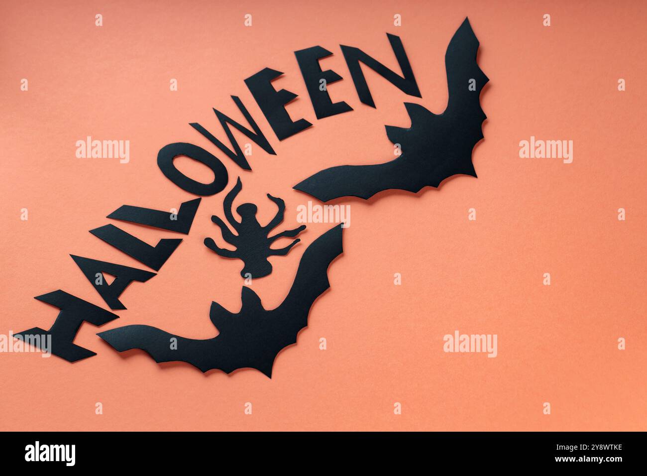 Black Paper Cutouts of Bats, Spiders and Halloween Text on Orange ...