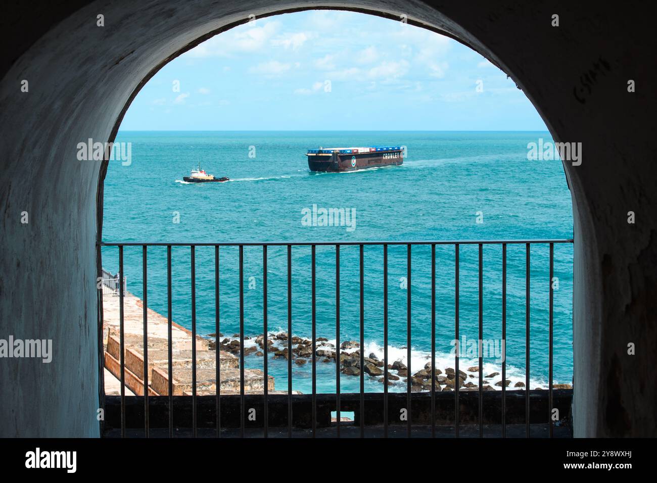 San Juan, Puerto Rico - April 20, 2017: A barge towed by a tugboat seen ...