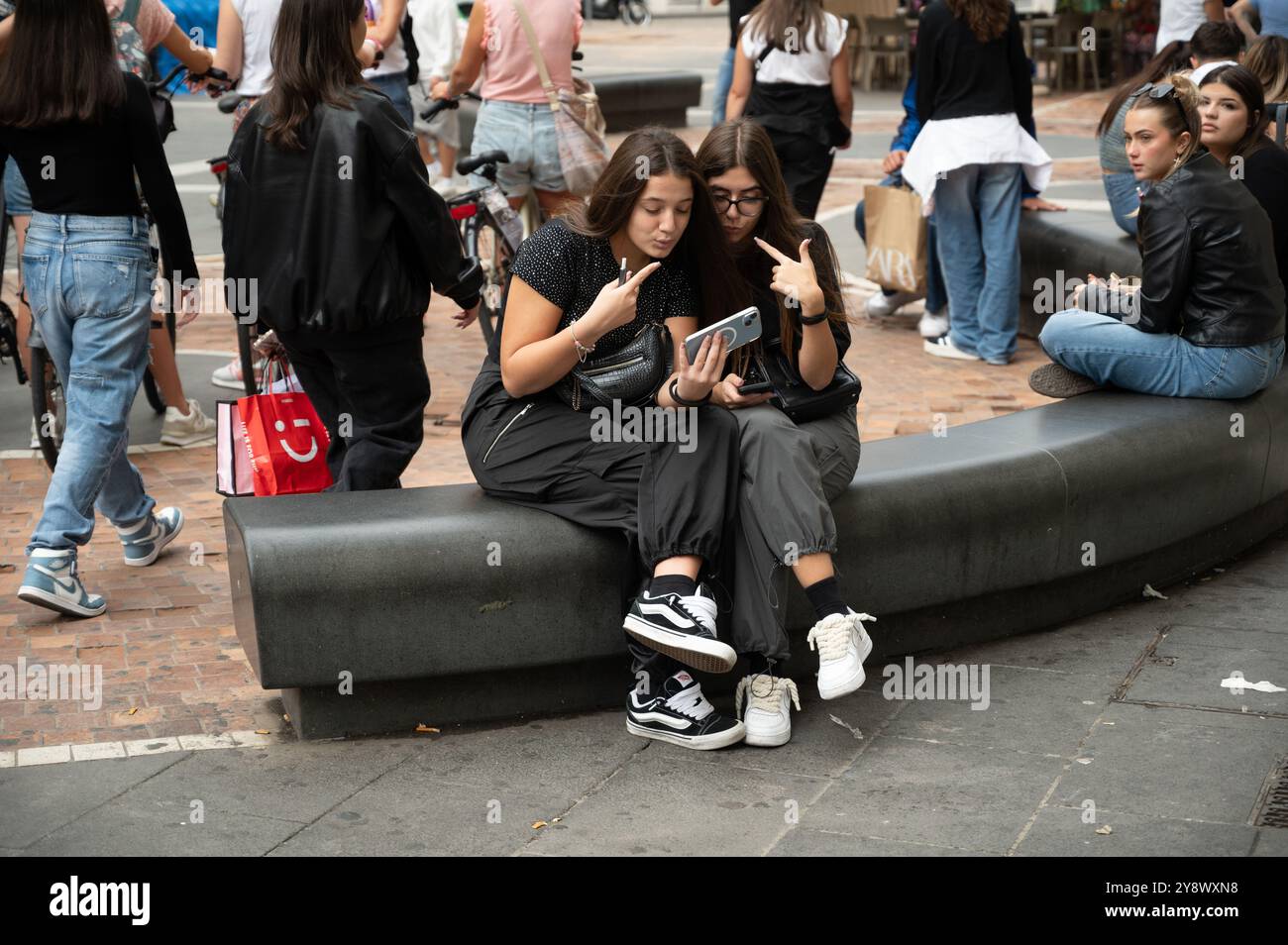2 teenage girls in Naples, Italy making a Tiktok Stock Photo - Alamy