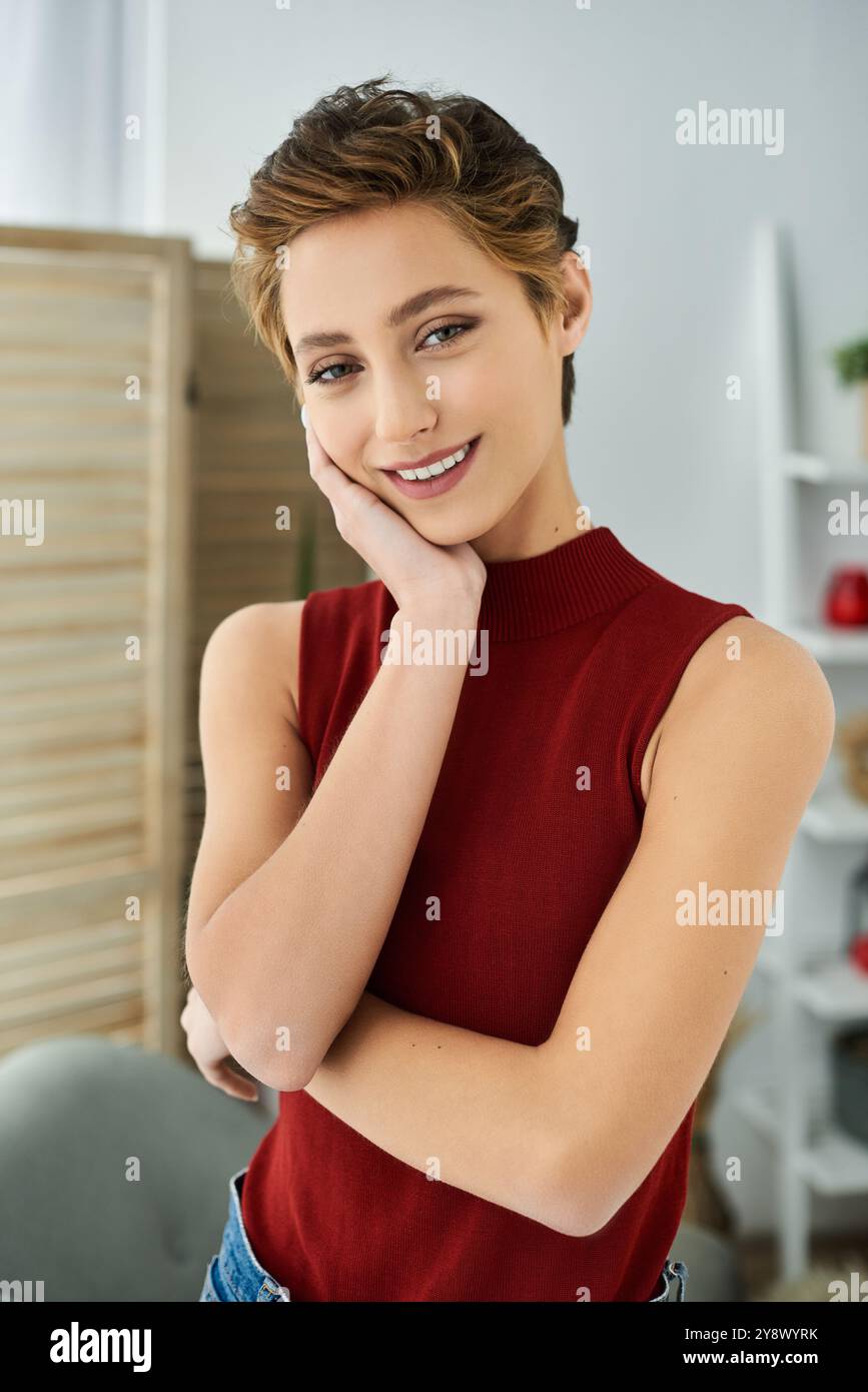 A young woman in a red tank top smiles warmly while embracing her ...