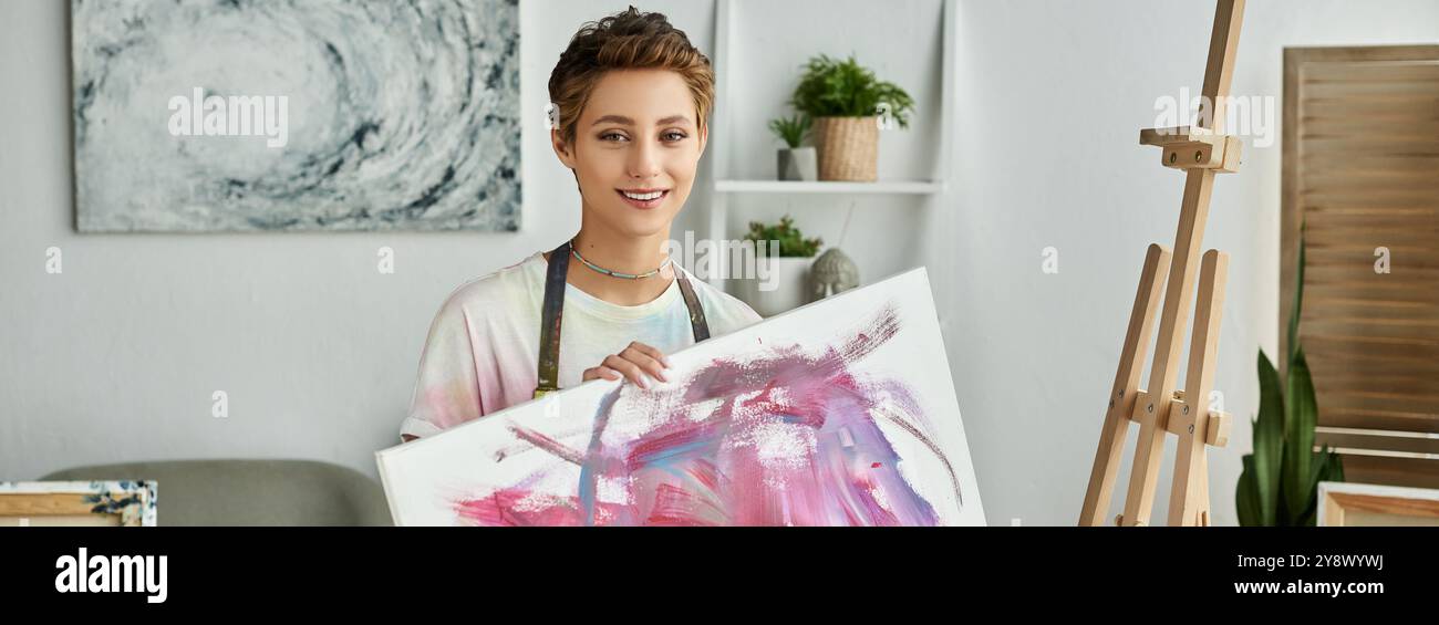 At home, a young woman expresses her creativity as she paints a ...