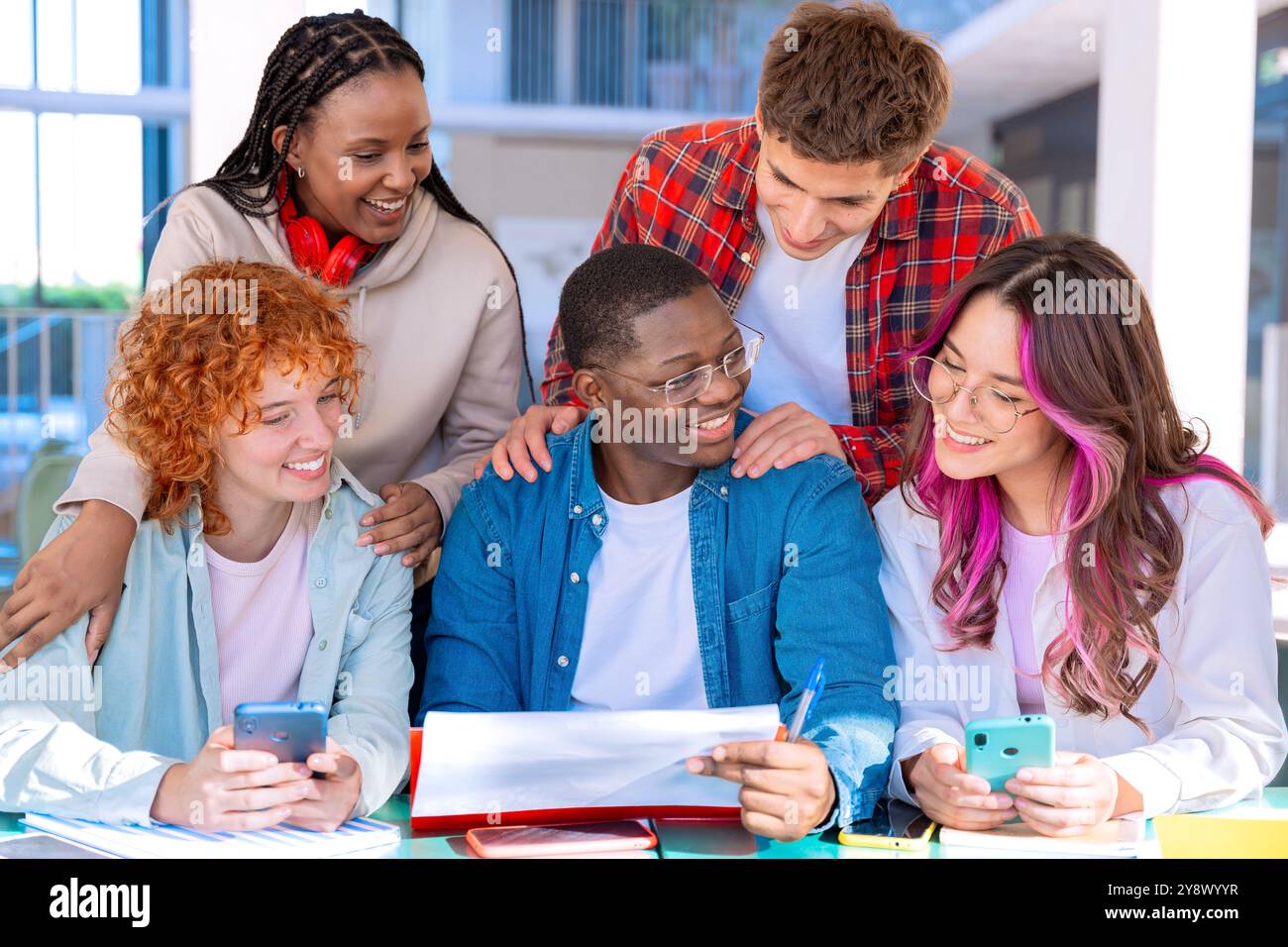 Happy diverse group of students studying in the library Stock Photo - Alamy