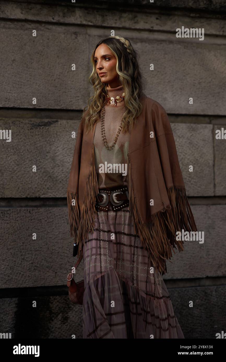 Cris Mata wearing turtle neck sweater, a plaid skirt, wrapped sweater ...