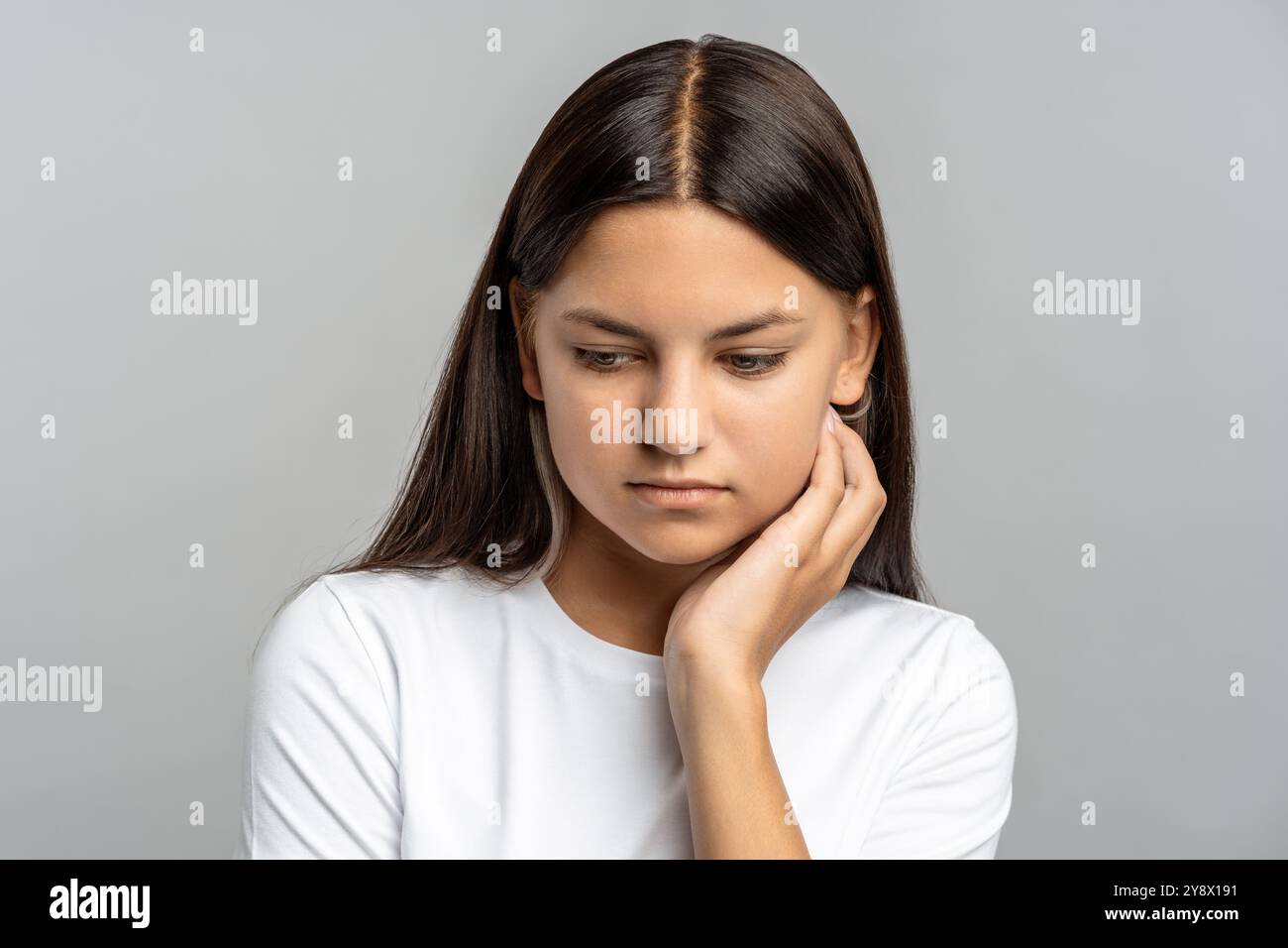 Shy schoolgirl avoiding eye contact, struggling with fear and ...