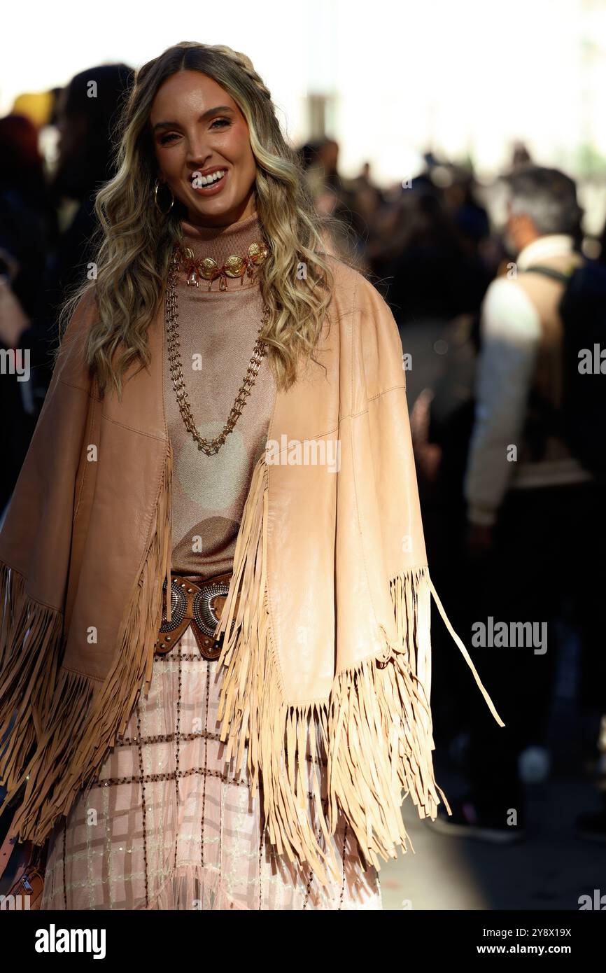 Cris Mata wearing turtle neck sweater, a plaid skirt, wrapped sweater ...