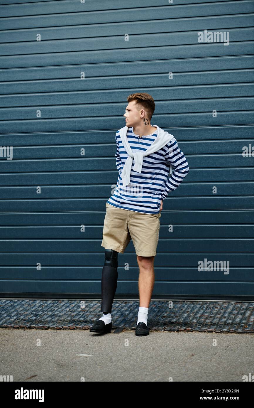 Confident young man stands tall, showcasing his stylish outfit and ...