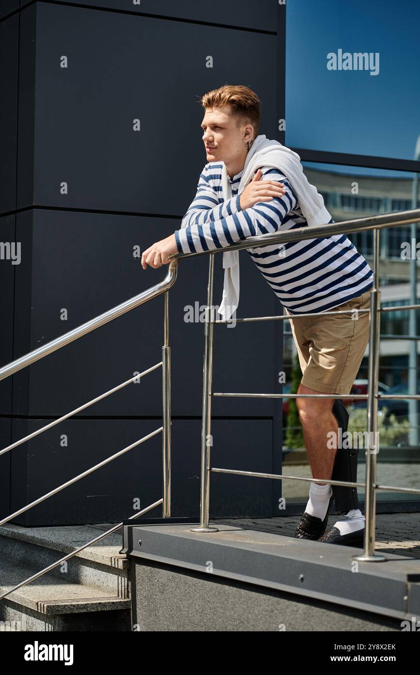 A young man leans casually against a railing, showcasing his prosthetic ...