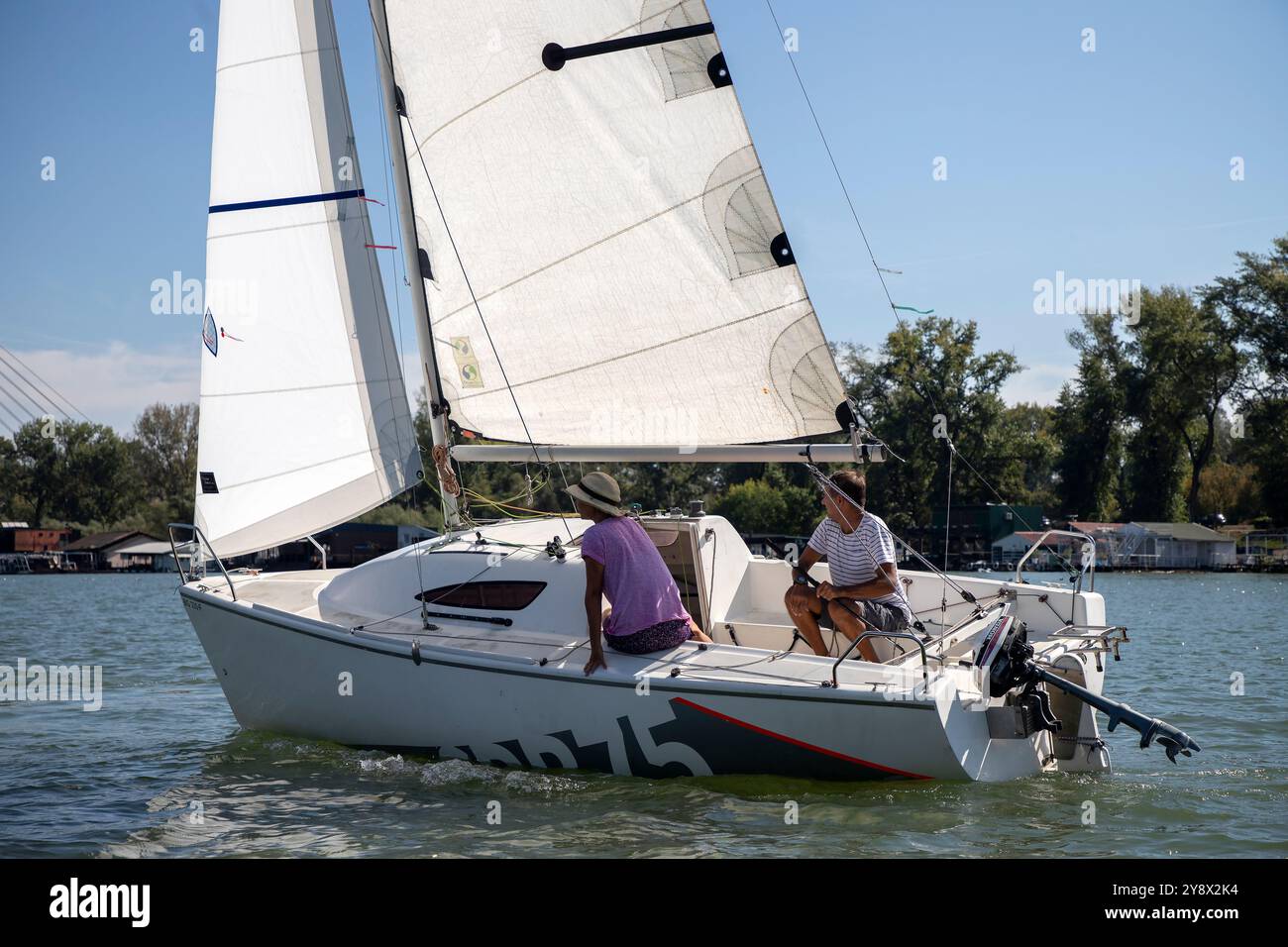 Serbia, Sep 28, 2024: A couple navigates a Micro Class sailing yacht ...