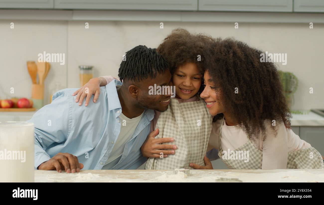 African American ethnic happy family at kitchen hugging biracial father ...