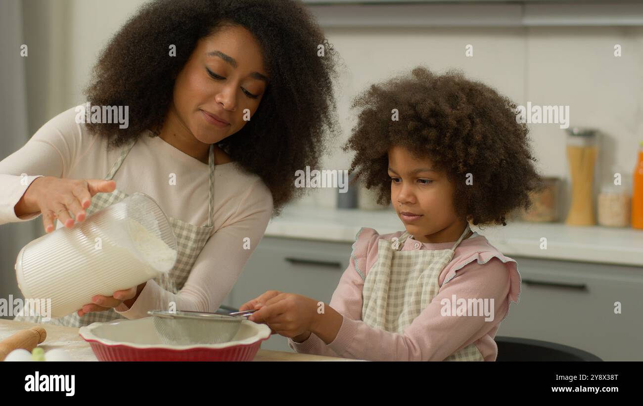 African American family cooking together mother woman mom teach little ...