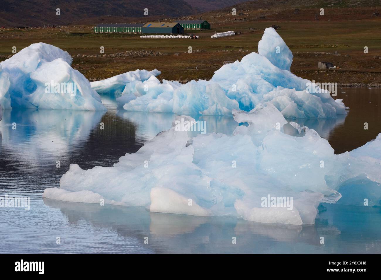 Iceberg and Farm in Eqaluit Ilua, Greenland Stock Photo - Alamy