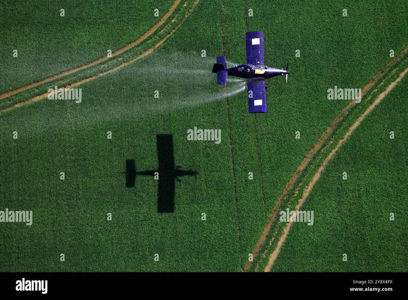 Aerial application of urea fertilizer to rice fields near Almyra ...