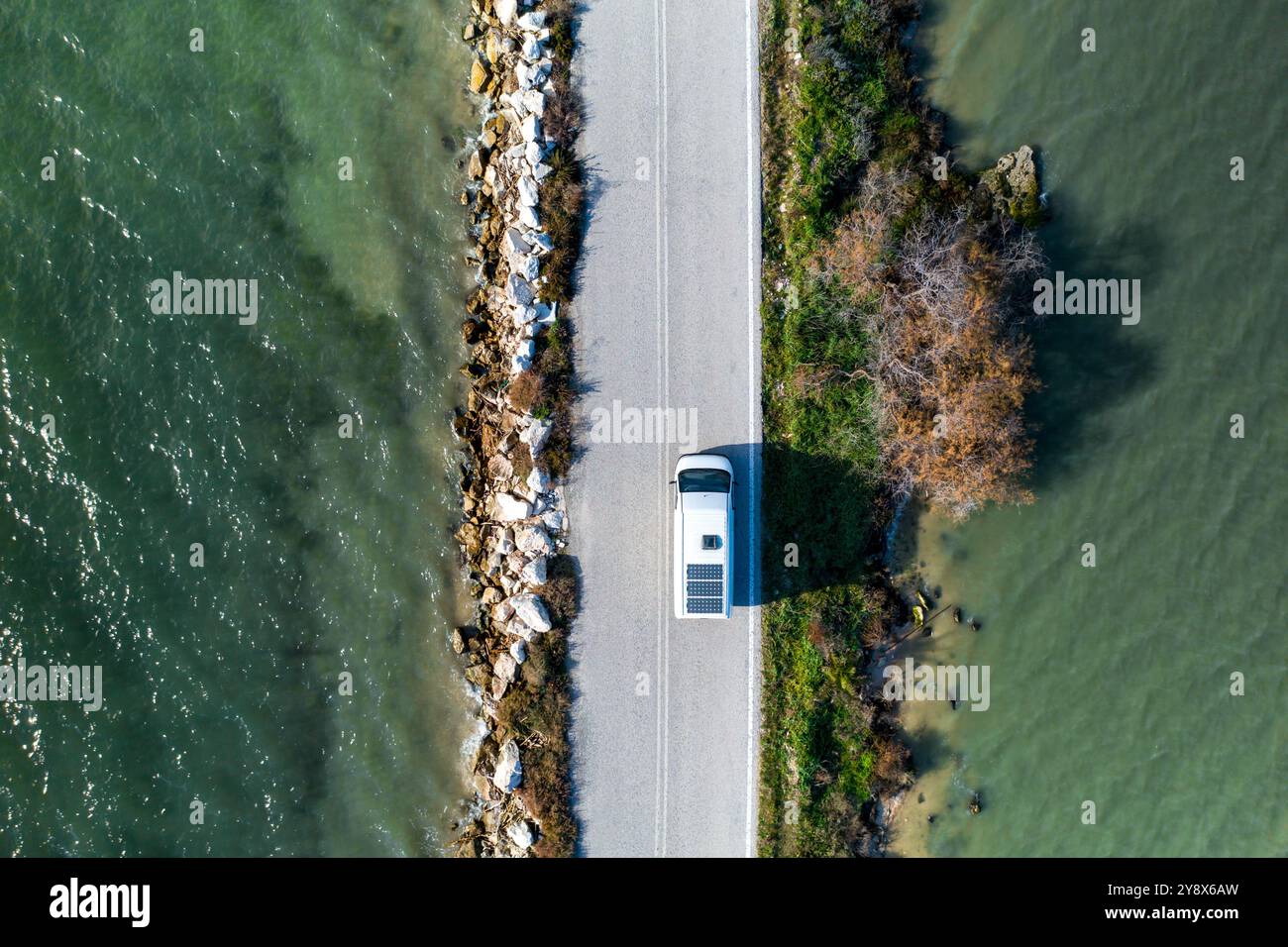 Drone top view of a camper van on a road between two lakes Stock Photo ...