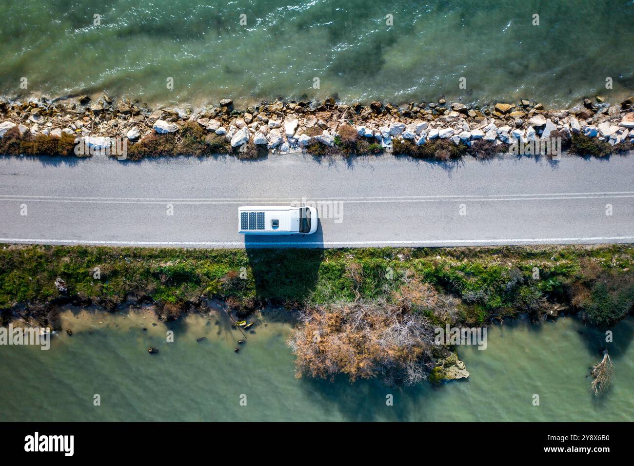 Drone top view of a camper van on a road between two lakes Stock Photo ...