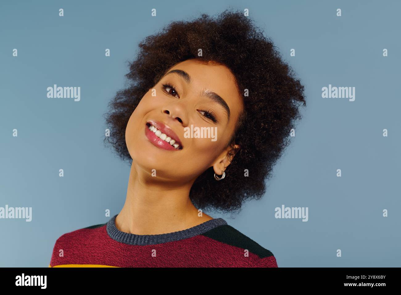 A young woman radiates happiness with a bright smile, showcasing her ...