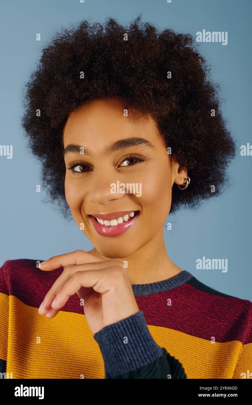 A young woman with an emotional smile showcases her joy in a colorful ...