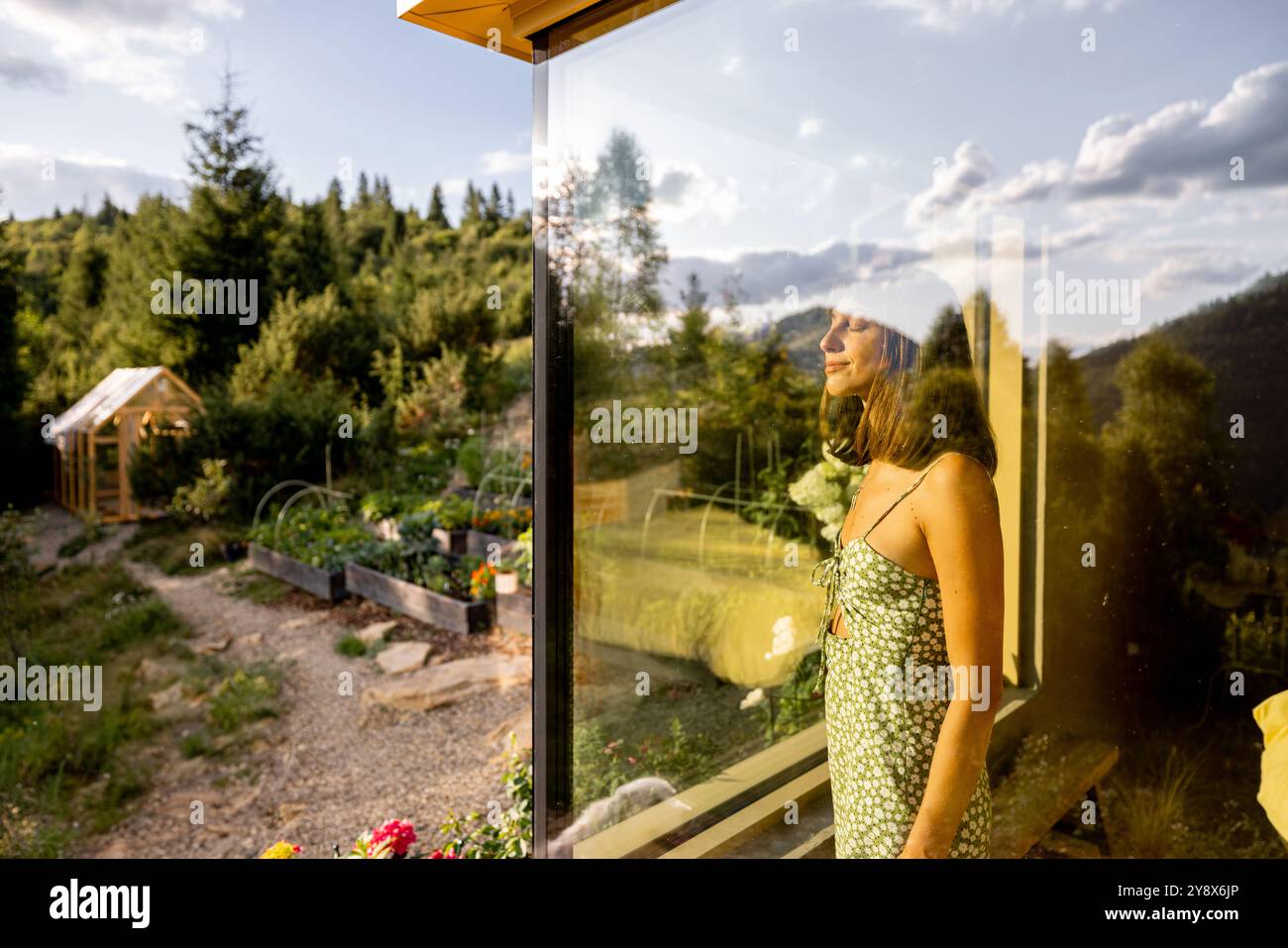 Woman Reflecting by the Window of a Modern House in Nature Stock Photo ...