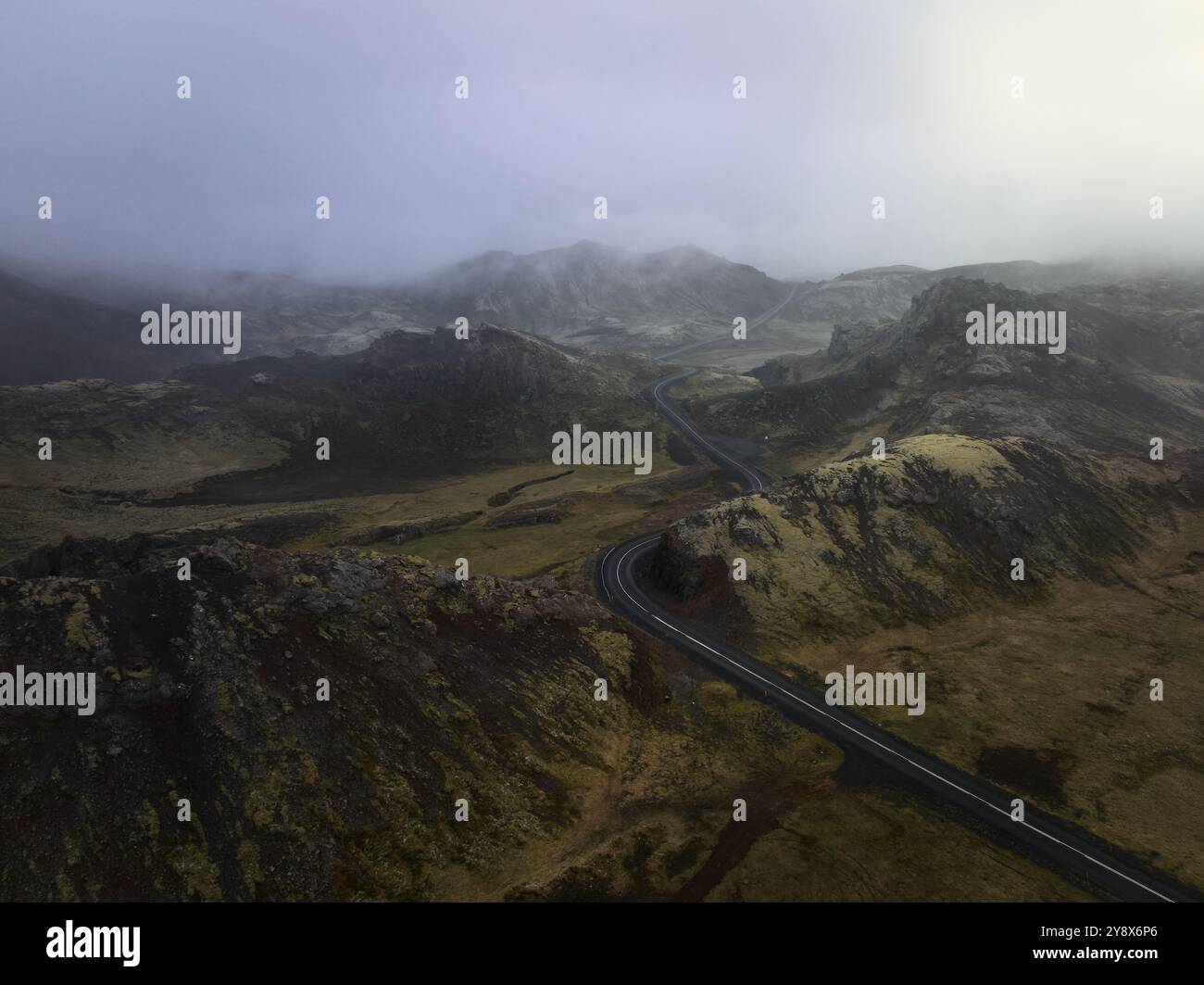 Drone view of asphalt road traversing through mountainous terrain Stock ...