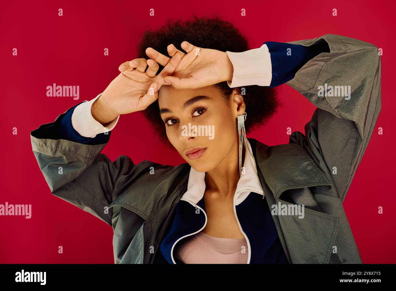 A young woman showcases deep emotion while striking a dynamic pose ...