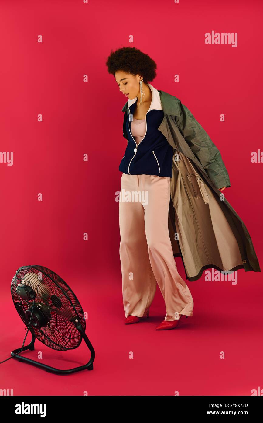 A young woman expresses deep emotions while styled in trendy attire ...