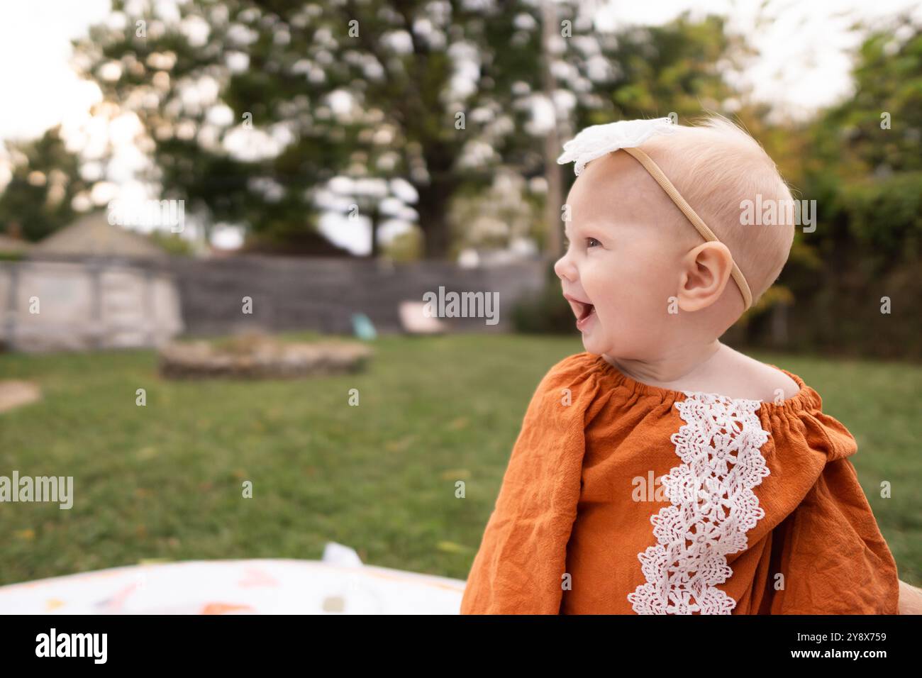Happy Baby Smiling Outside In The Backyard Stock Photo - Alamy