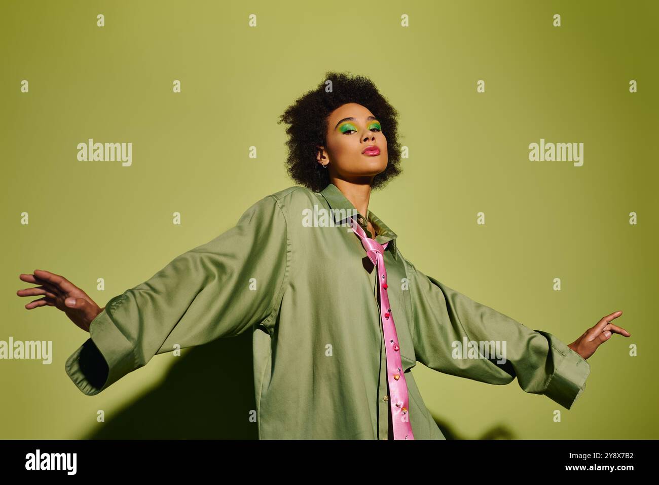 A young woman poses gracefully in unique fashion against a vibrant ...