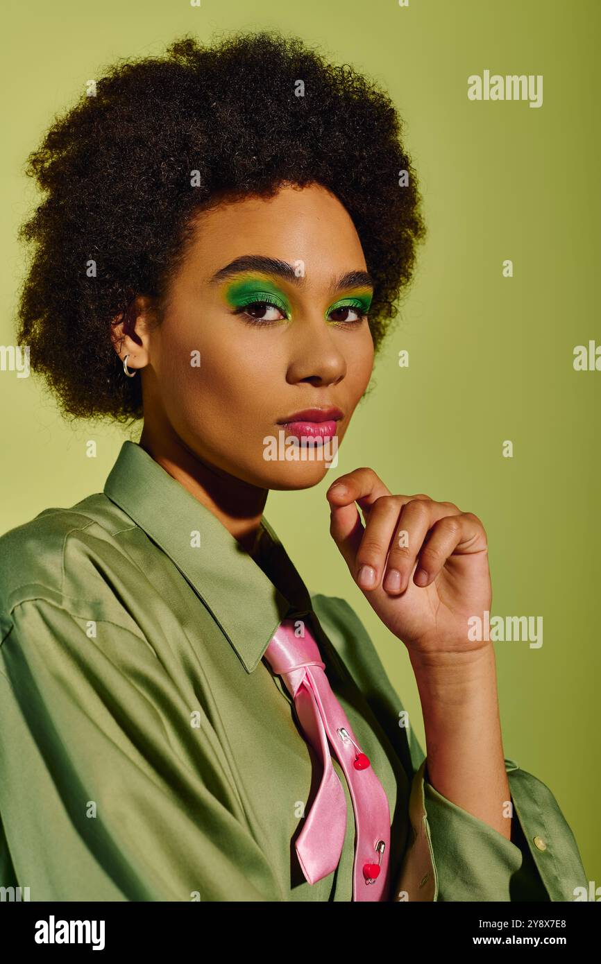 The young woman showcases vibrant green makeup while conveying deep ...