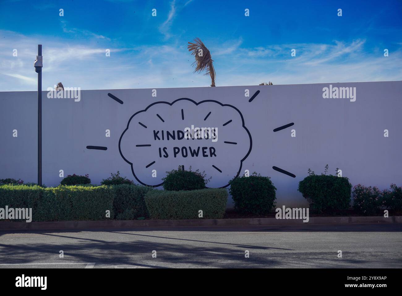 A white wall adorned with a hand-drawn cloud illustration featuring the ...