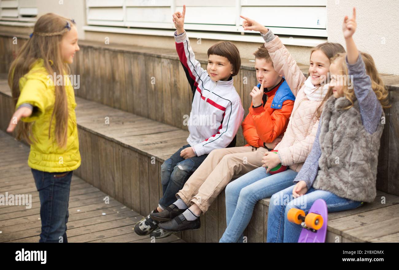 Children on bench playing children's games Stock Photo - Alamy