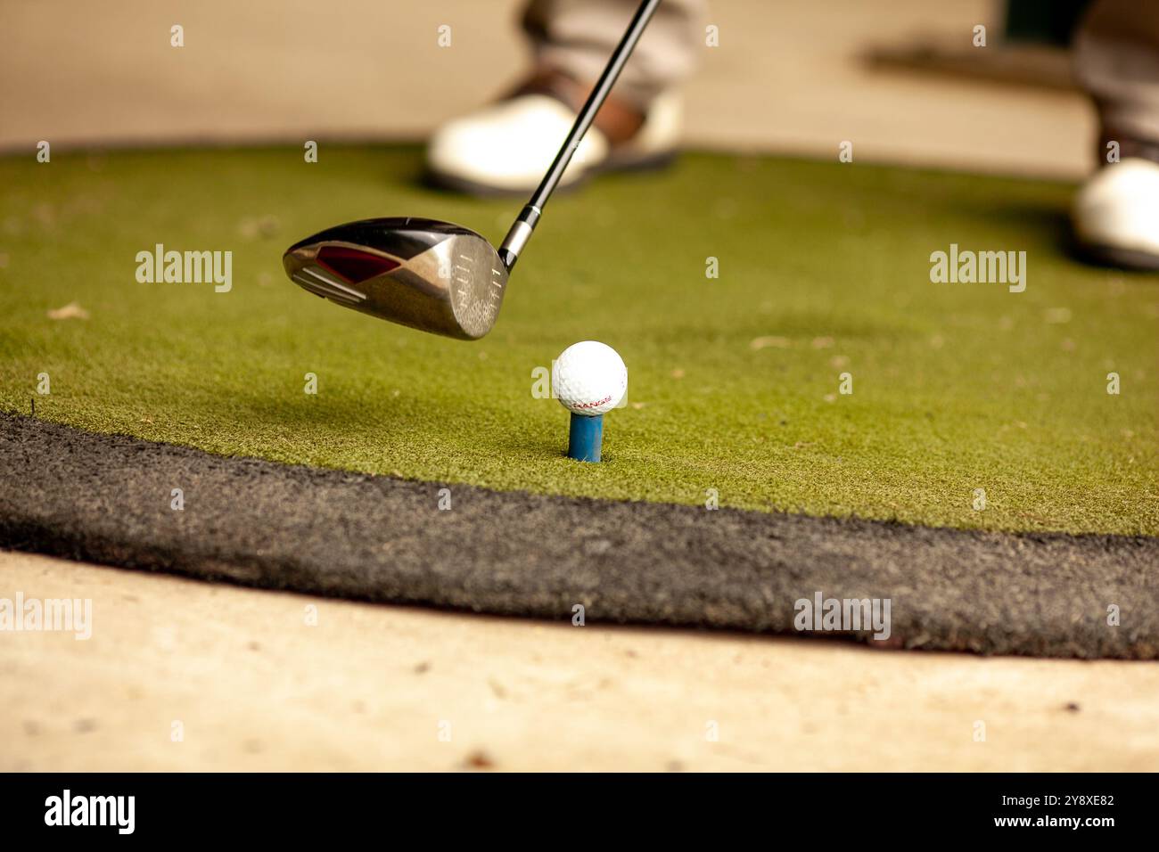 golf practising range matt, golfers shoes club , ball Stock Photo - Alamy