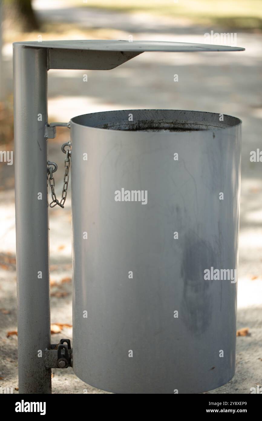 Grey waste bin in the park, modern design Stock Photo - Alamy