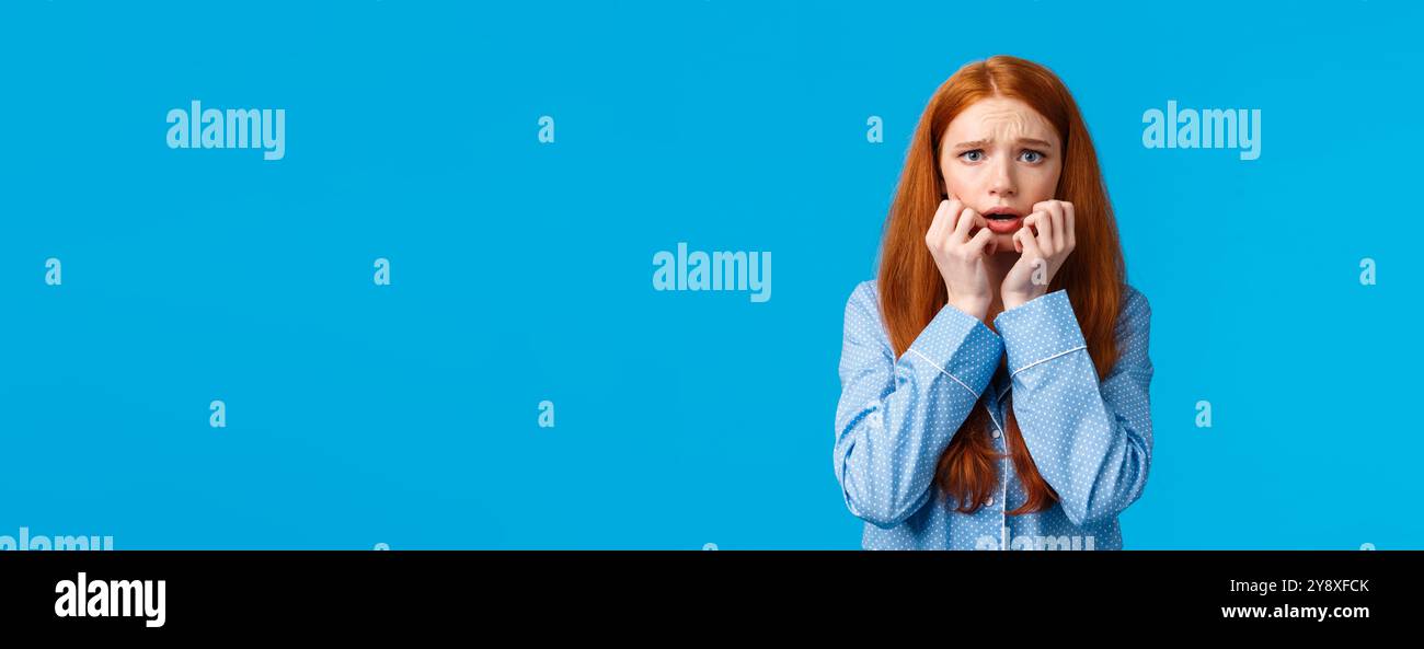 Scared and panicking young worried redhead teenage girl having ...
