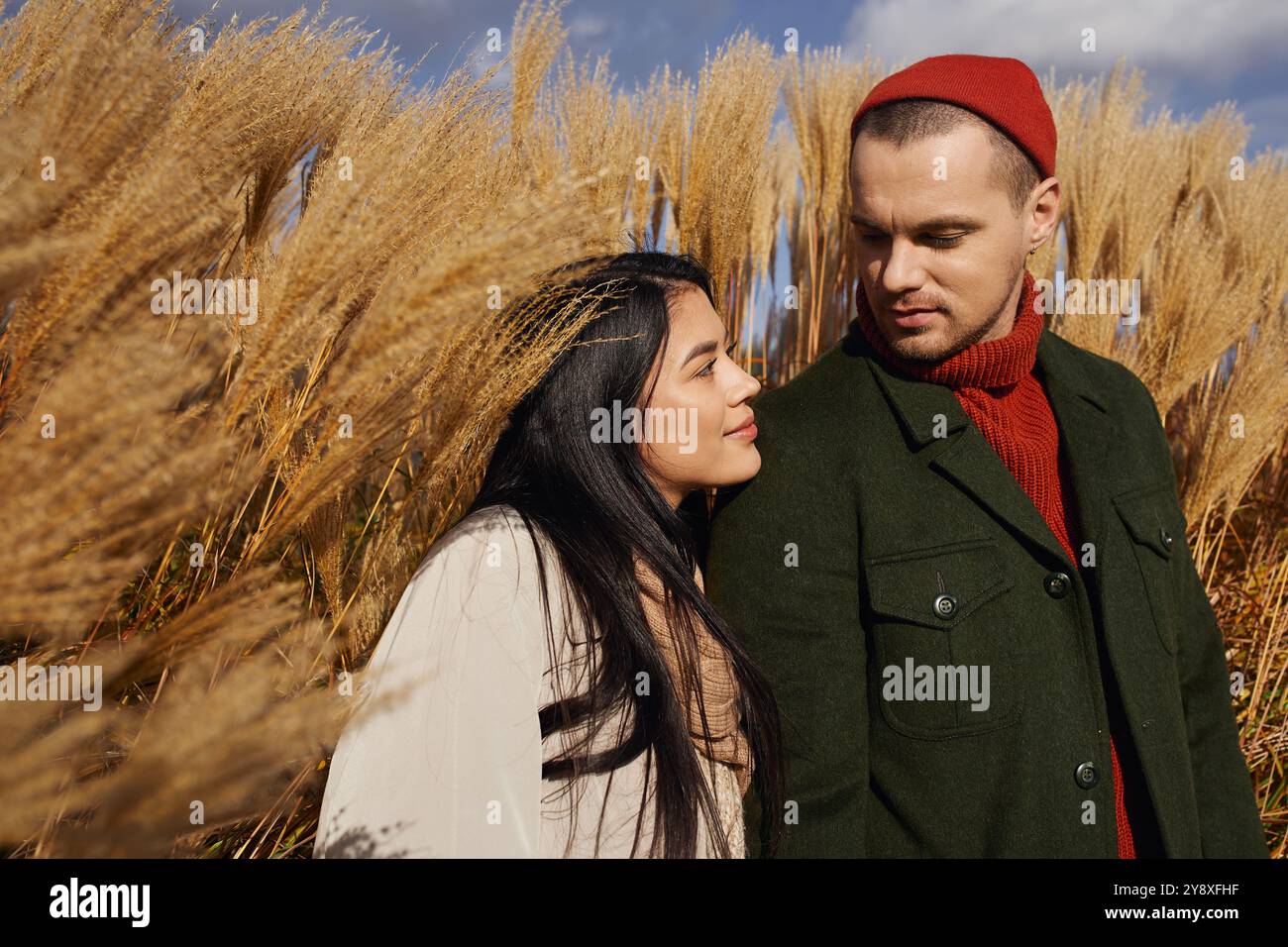 A loving couple embraces each other warmly, surrounded by golden autumn ...