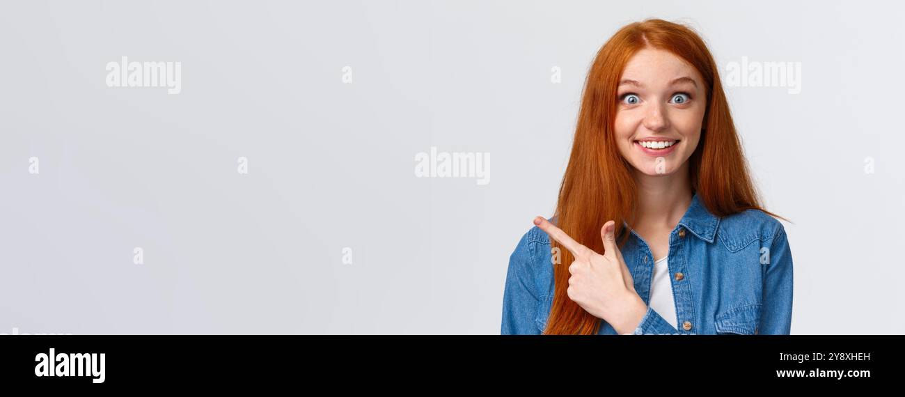 Excited and impressed, curious thrilled smiling redhead girl with long ...