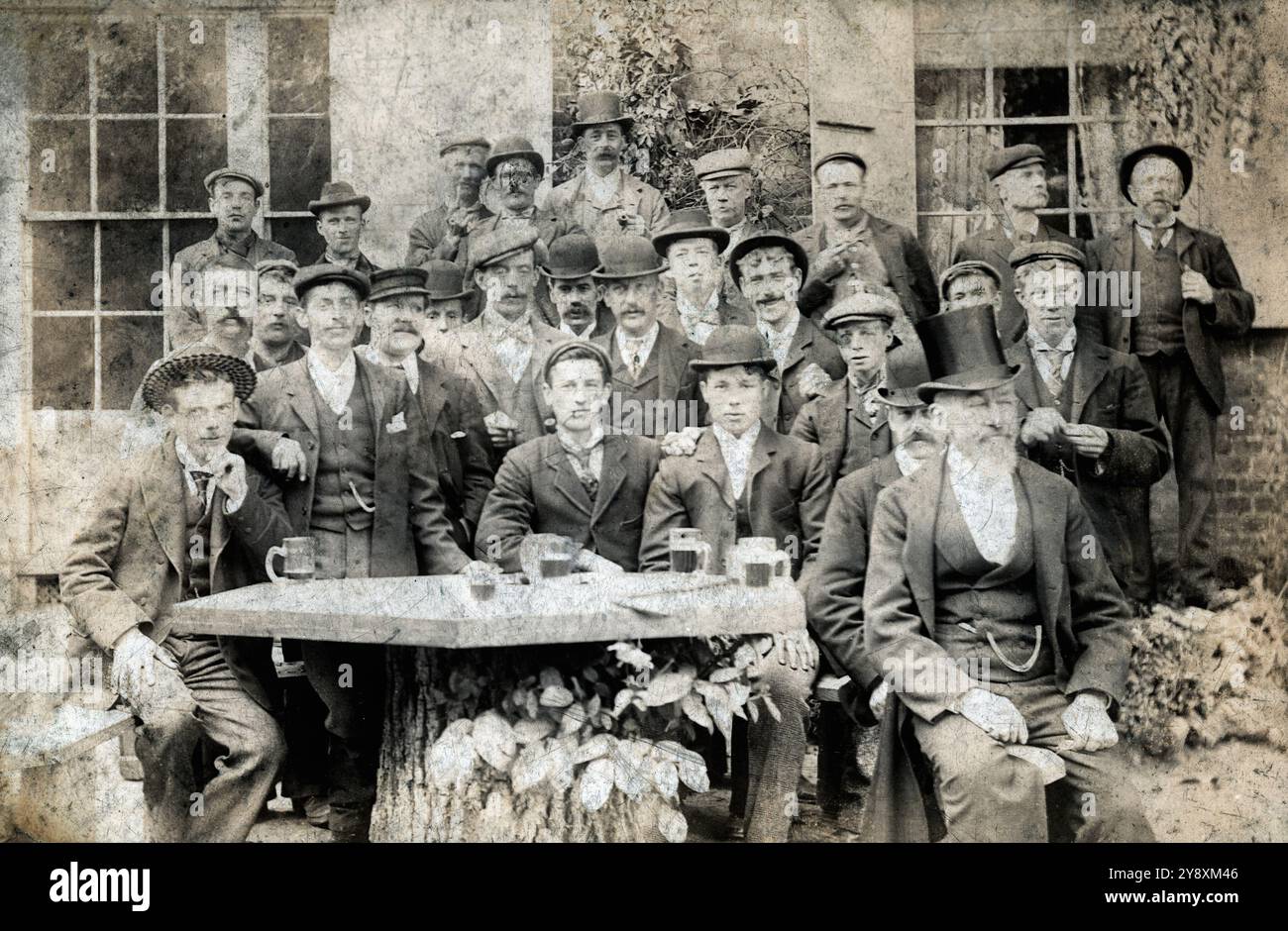 Damaged group photo of English men enjoying their drink Stock Photo - Alamy