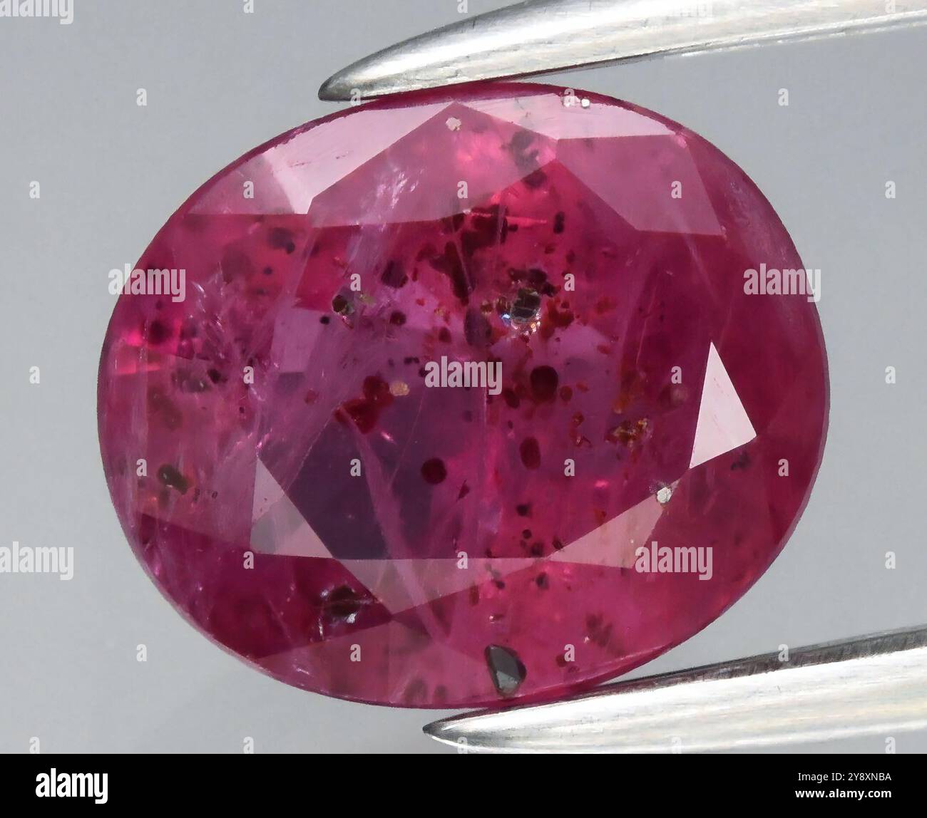 Radiant Deep Pink Ruby Gemstone with Intricate Inclusions and Faceted ...