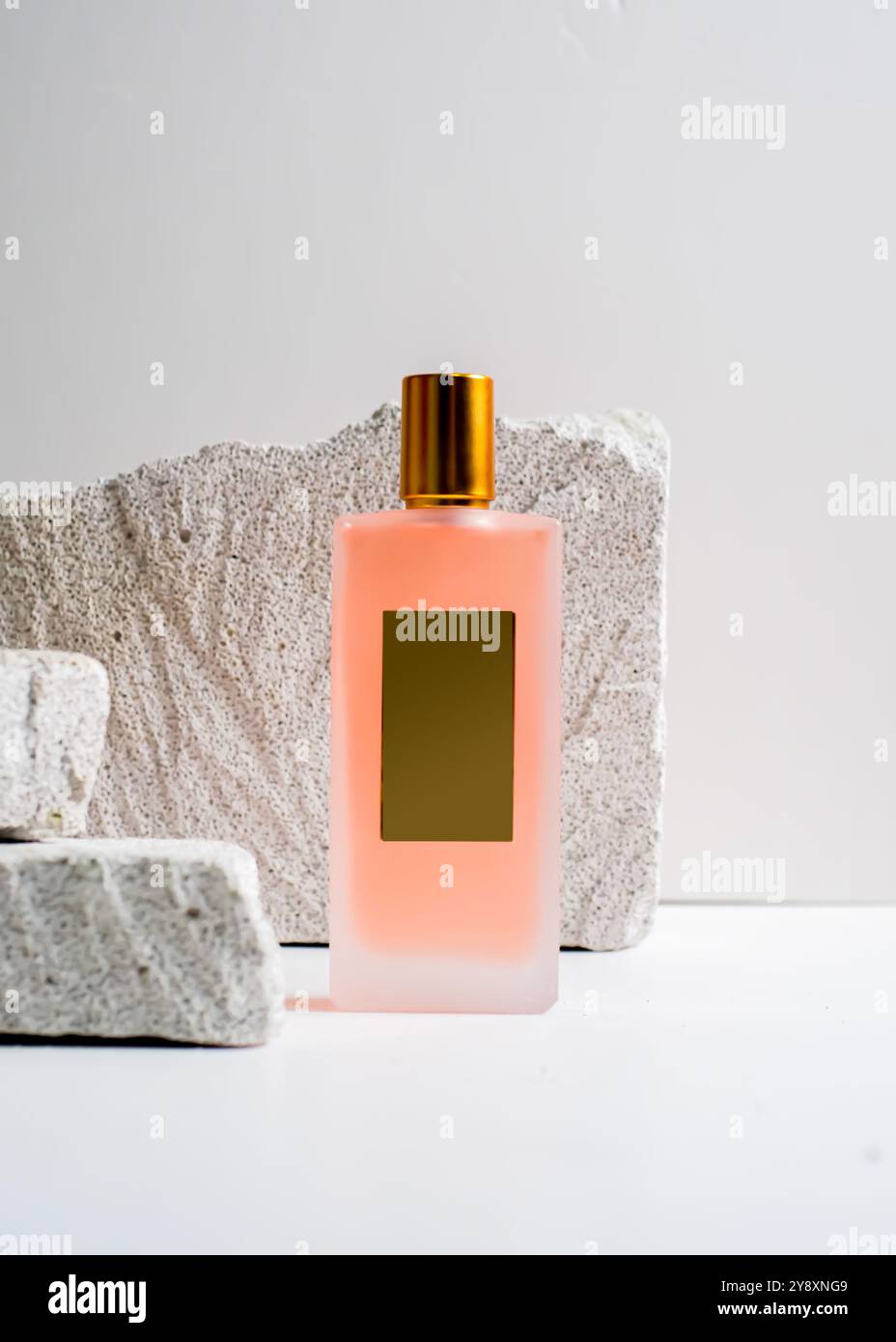 An elegant peach color spray perfume bottle showcased against a clean ...